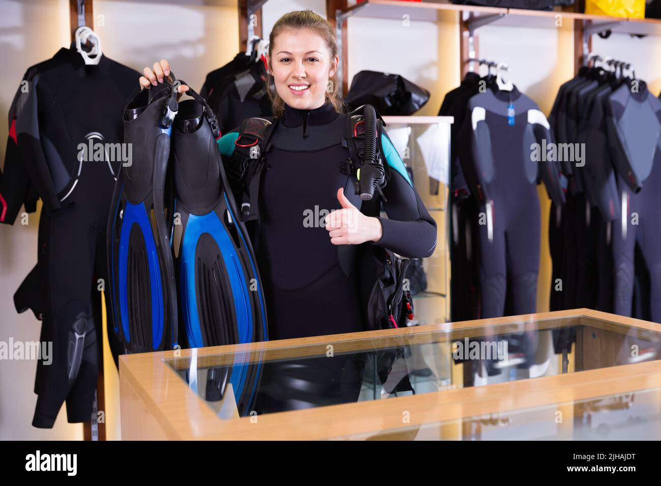 Sporty woman is satisfied of full set diving equipment in the diving ...