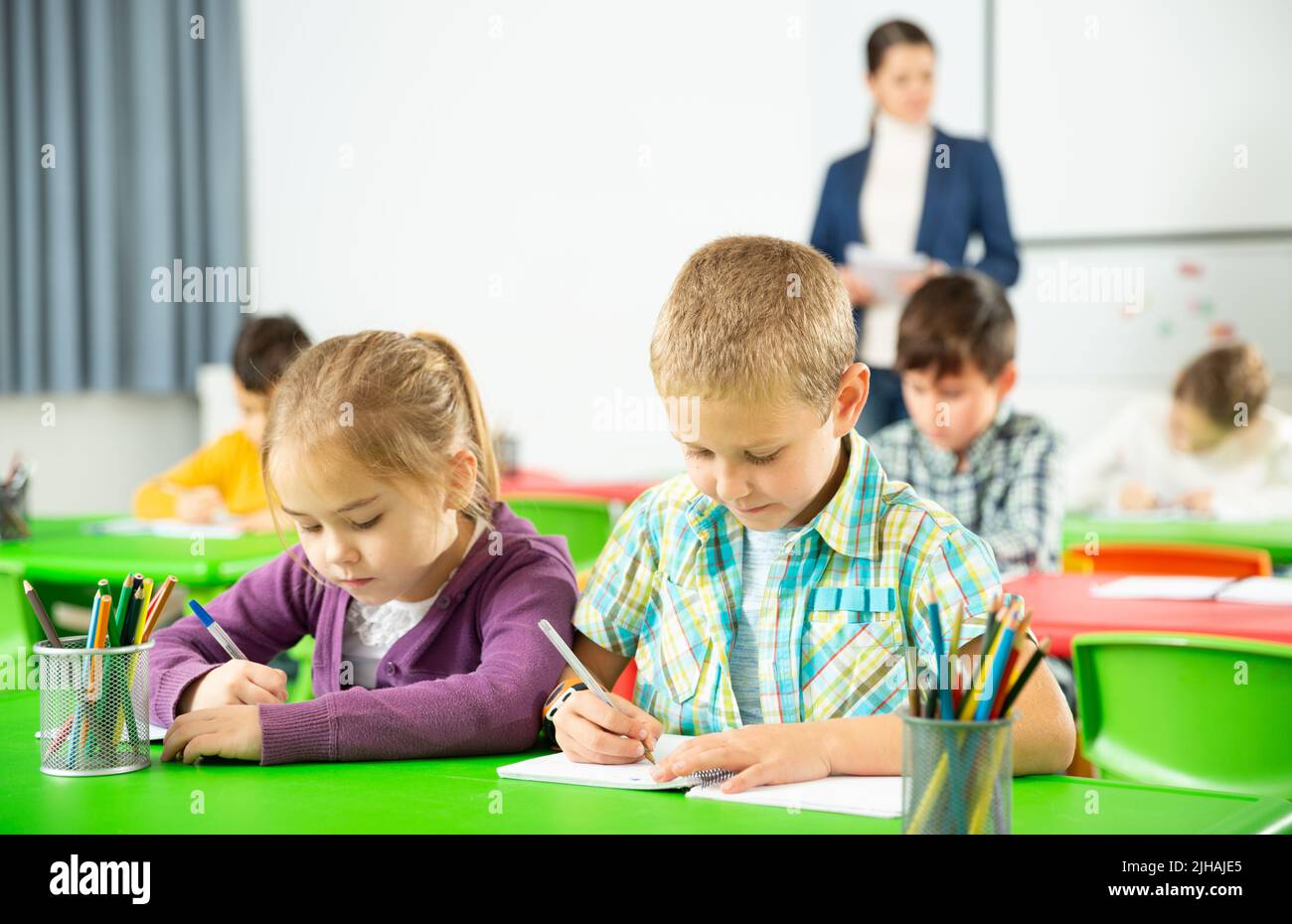 Assiduous kids studying in classroom Stock Photo - Alamy