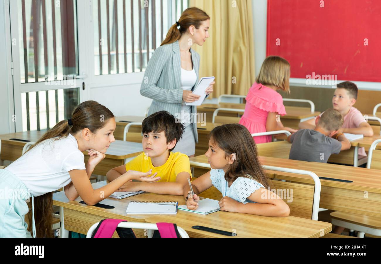 Tweens working in small groups during lesson at school Stock Photo - Alamy