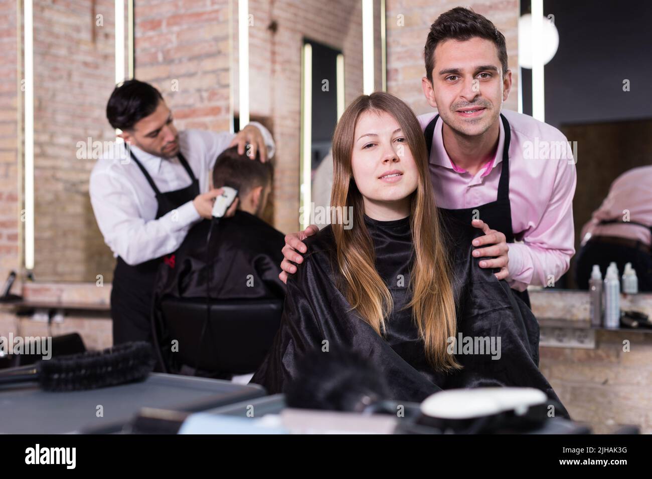 Female discussing haircut with hairdresser Stock Photo - Alamy