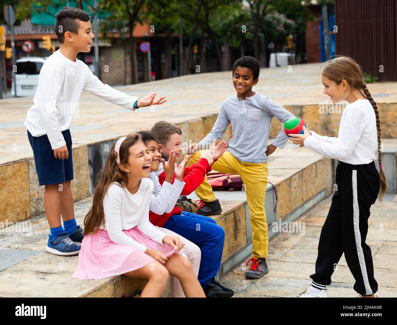 Cheerful tweens spending time together on city street Stock Photo - Alamy