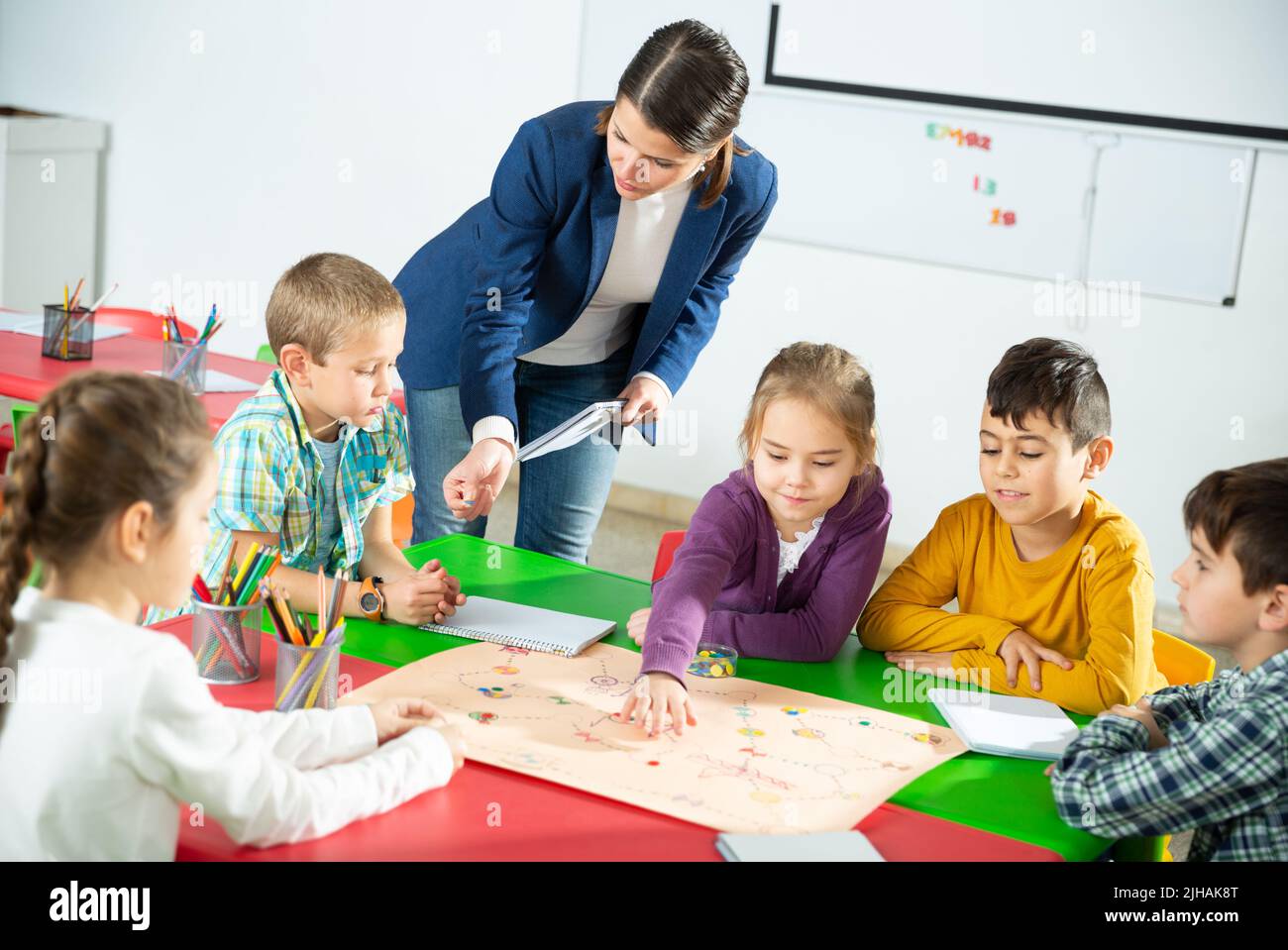 Kids with teacher playing educational tabletop game Stock Photo - Alamy Kids with teacher playing educational tabletop game Stock Photo - Alamy