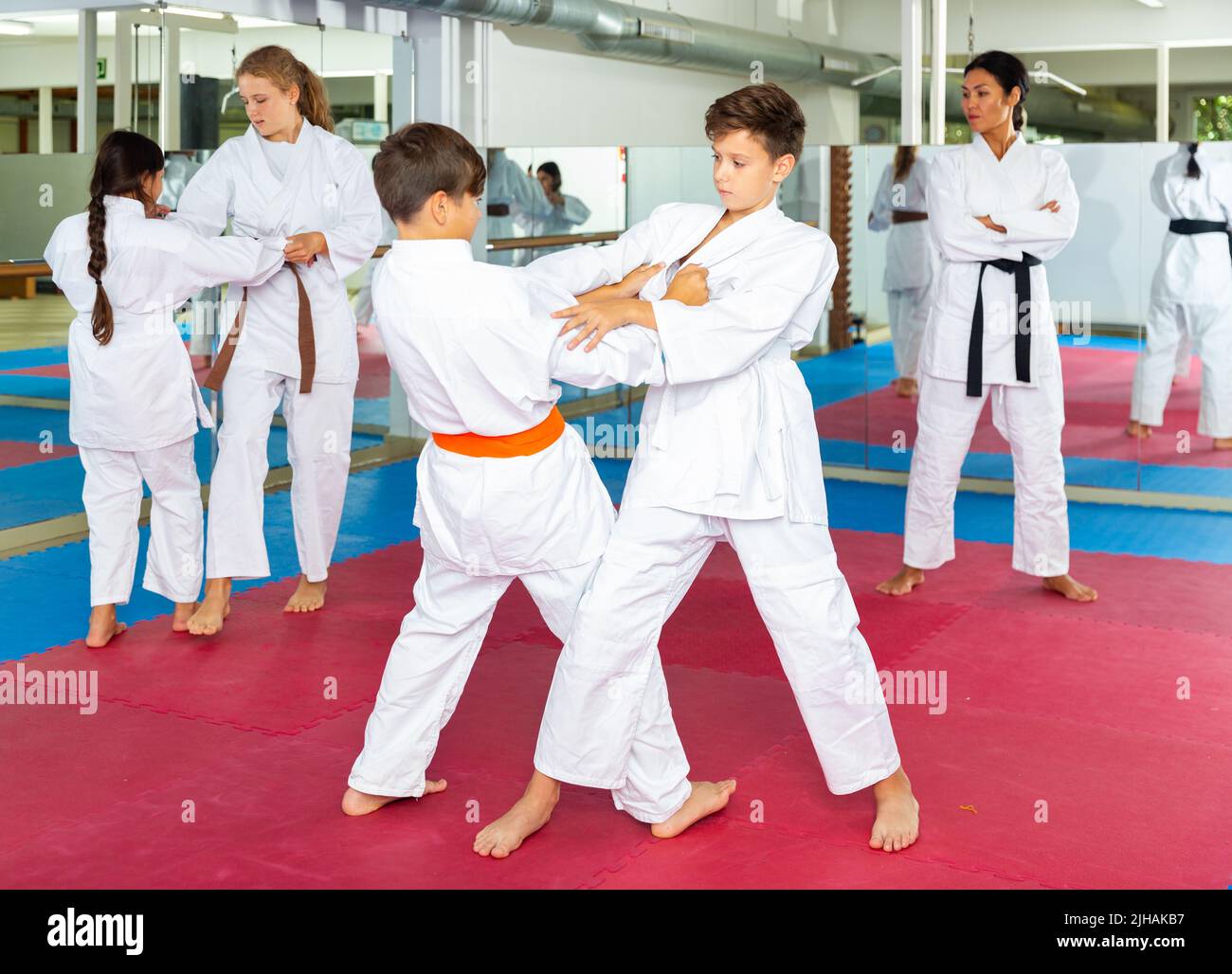 Young girls and boys sparring during karate training Stock Photo - Alamy