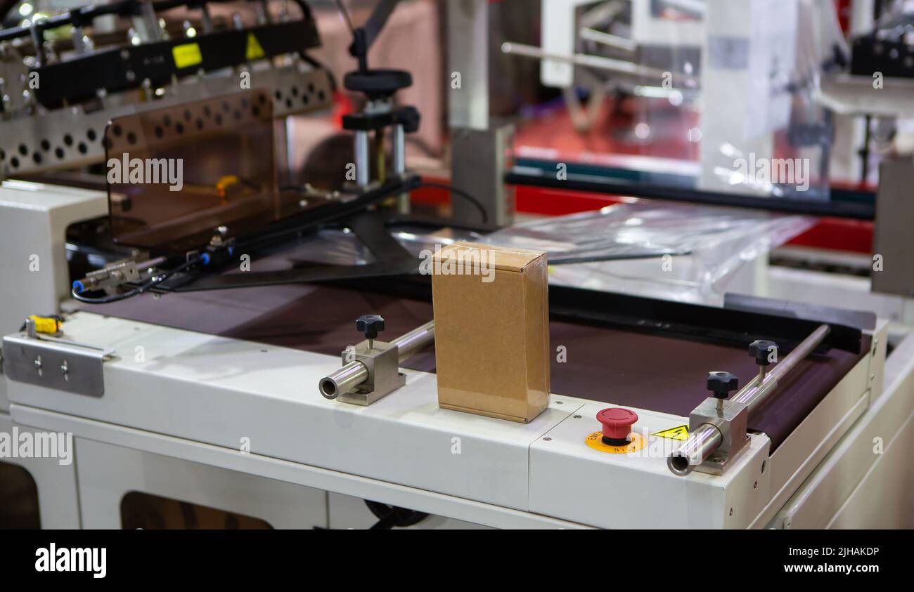 Shrink film package wrapping machine. Wraping packaging of box ...