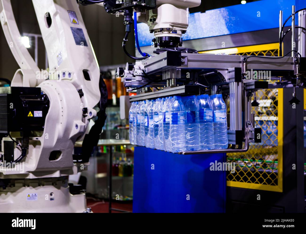 Robot arm lifting packages bottle of water in water bottling line Stock ...