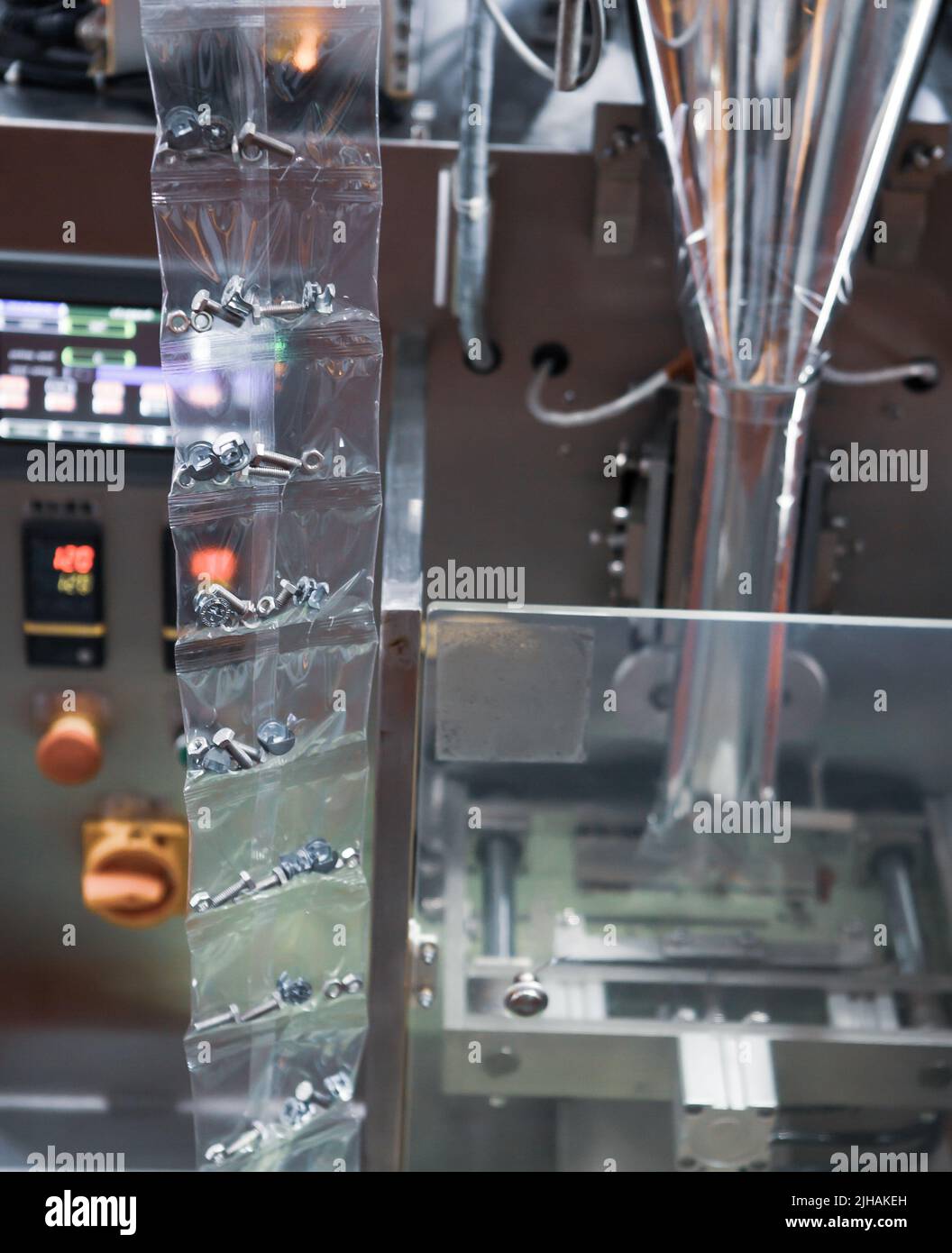 Screws and nuts packed in vertical pouch packing machine Stock Photo ...