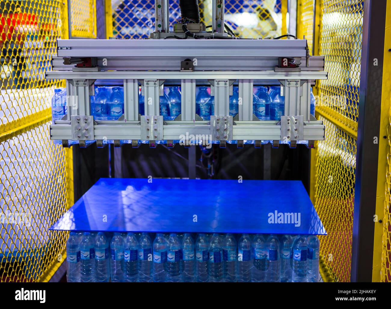 Robot arm lifting packages bottle of water in water bottling line Stock ...