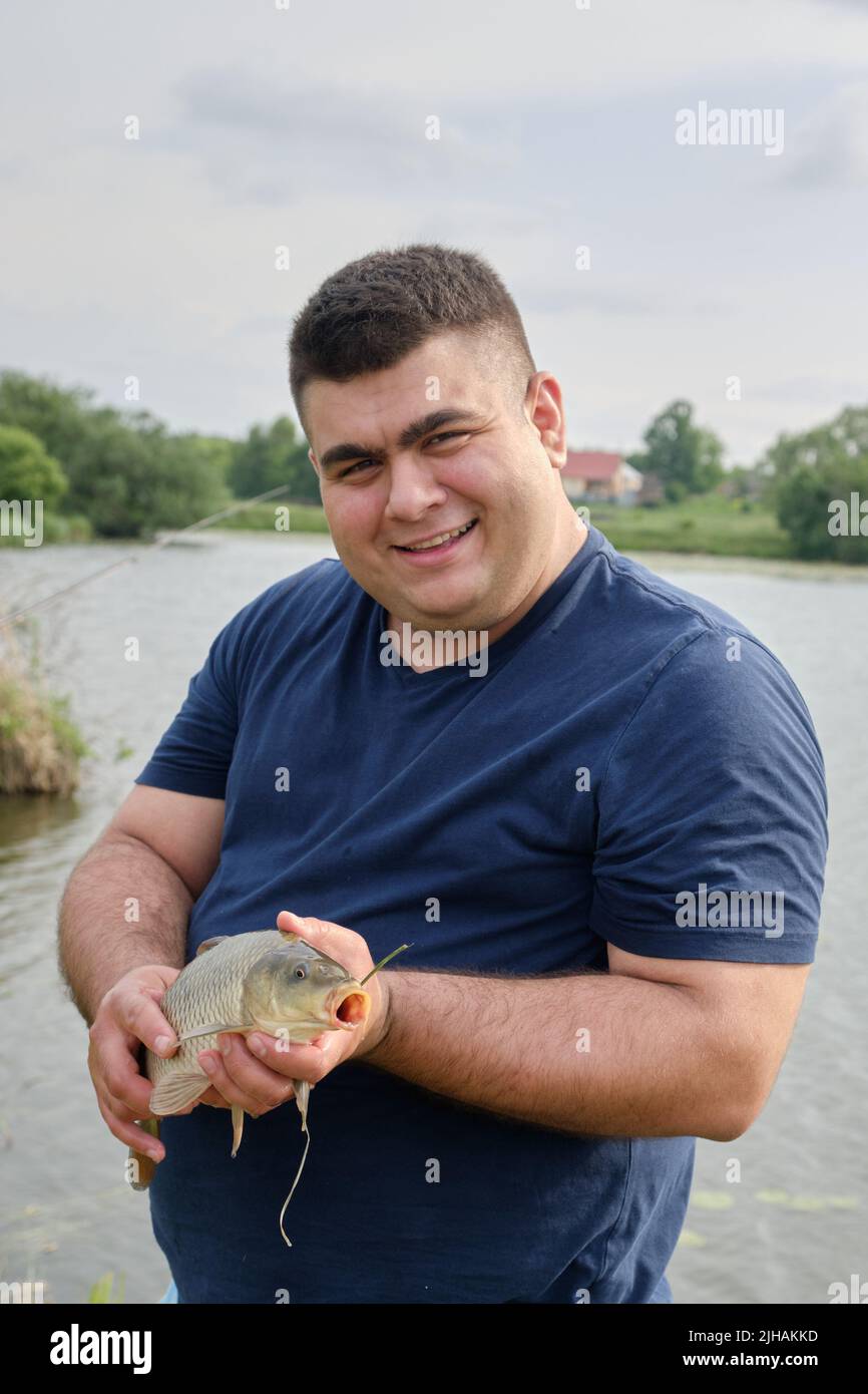 Man holding carp hi-res stock photography and images - Alamy