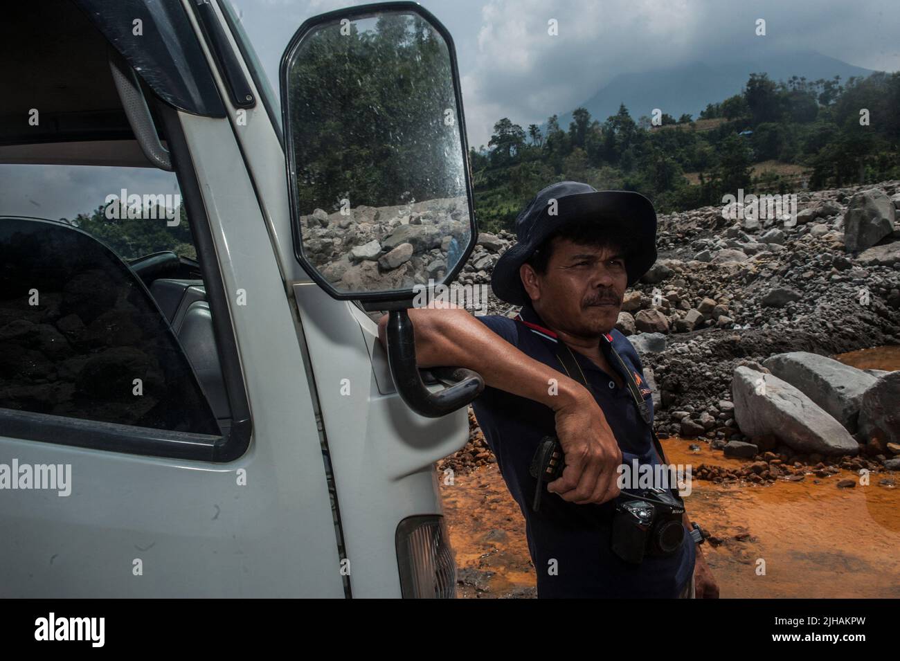 A truck driver, Sarianto Sembiring, 42, is seen loading mine sand ...