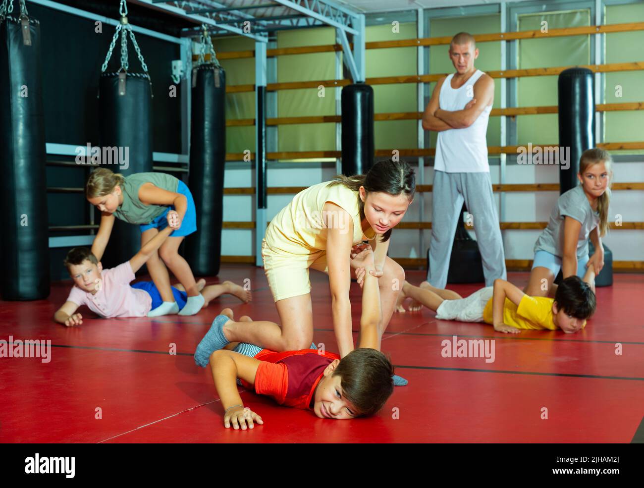 Kids in pair exercising self-defense movements Stock Photo - Alamy