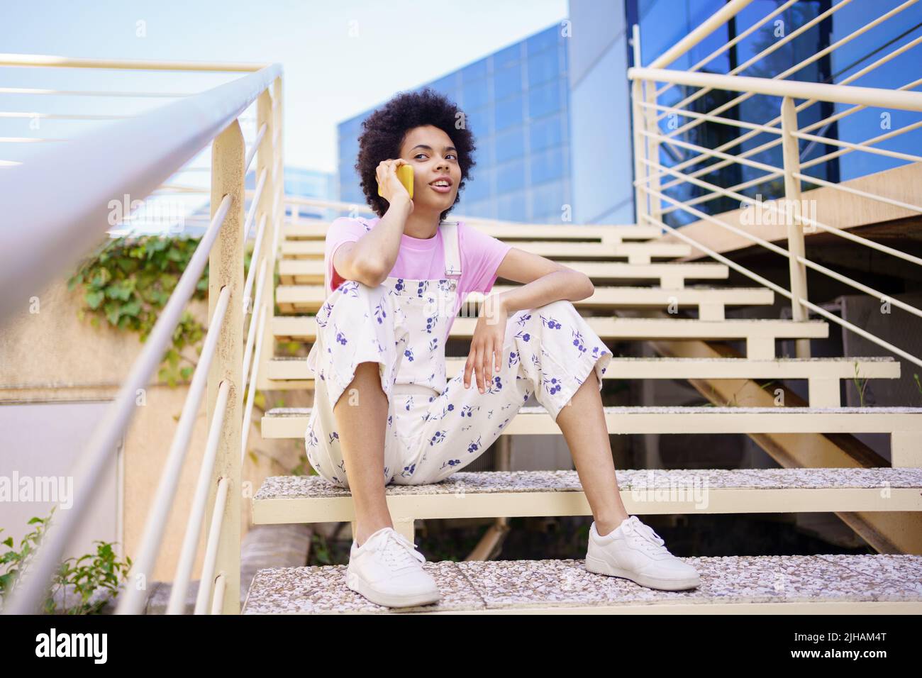 Black woman having phone conversation on staircase Stock Photo - Alamy