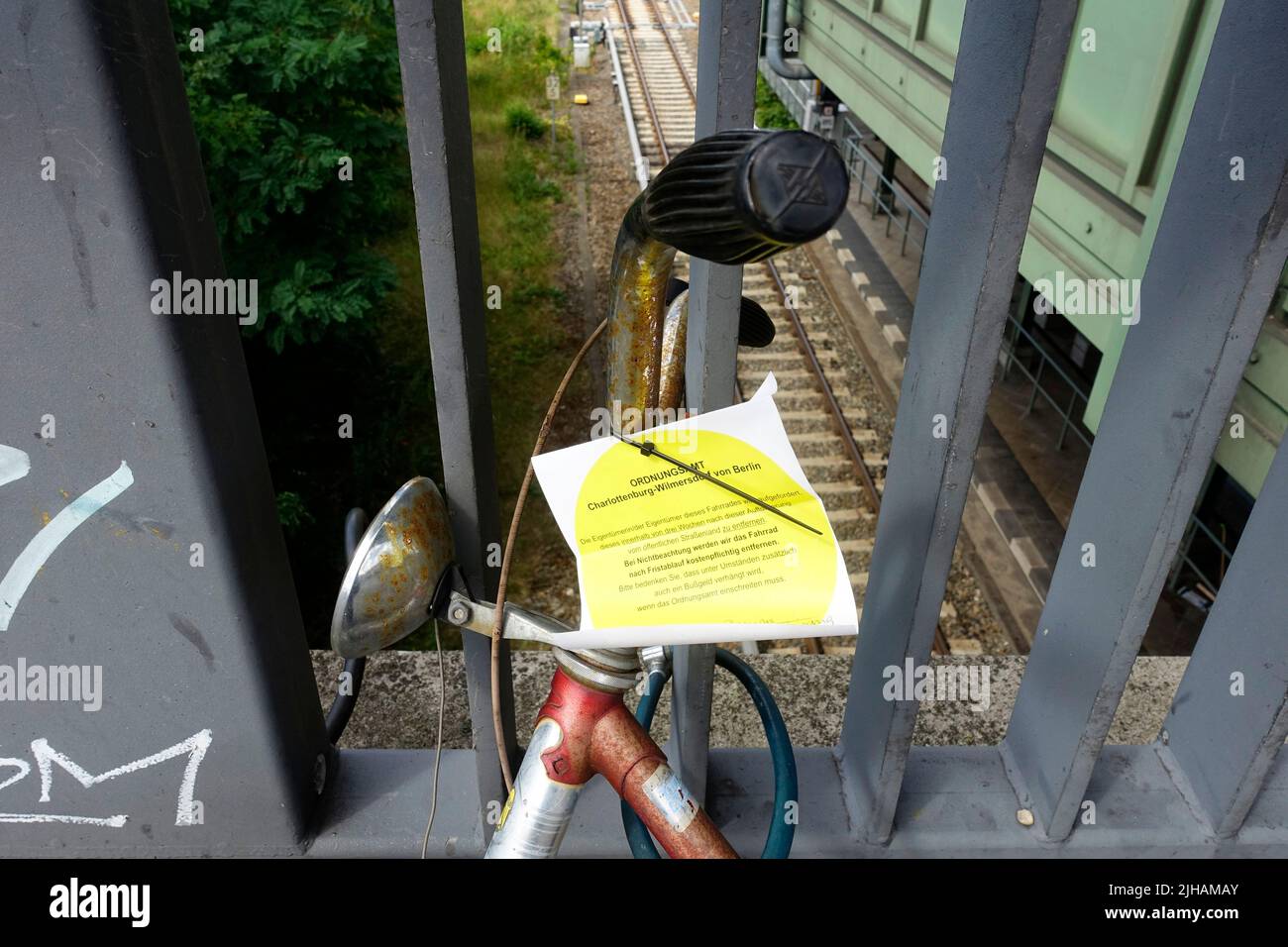 Defective bike with a yellow sign from the regulatory office in Berlin ...