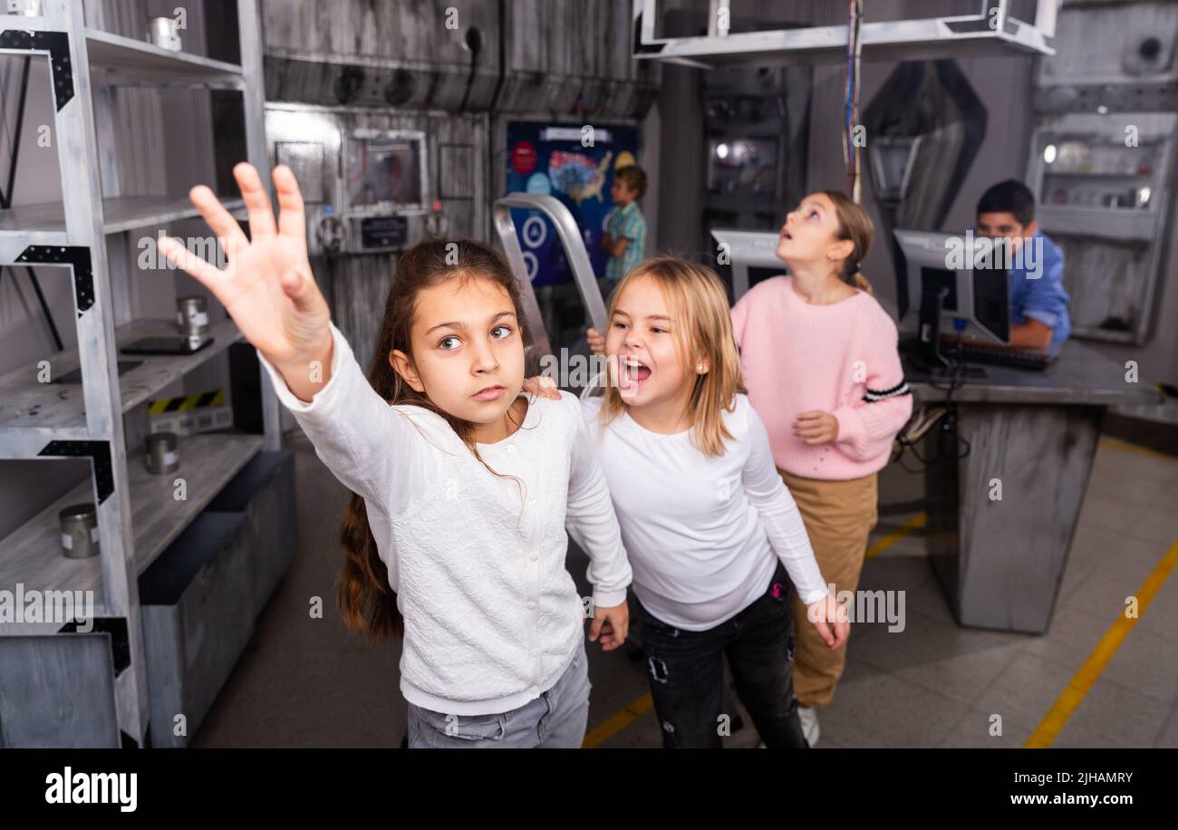 Girl looking for key to solve a puzzle in quest room Stock Photo - Alamy