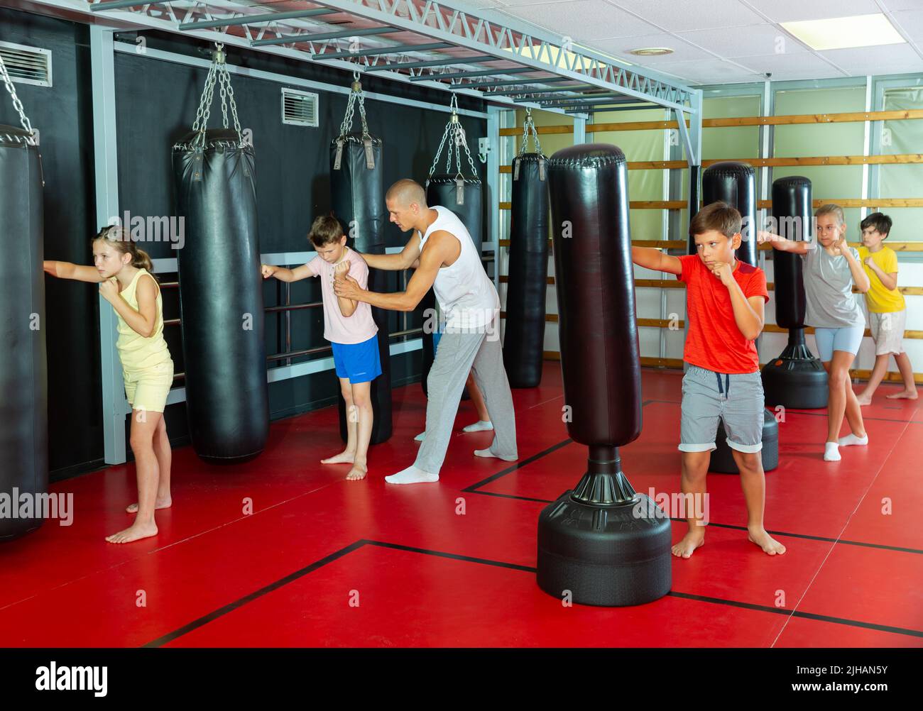 Group of kids boxing with punch bags Stock Photo - Alamy