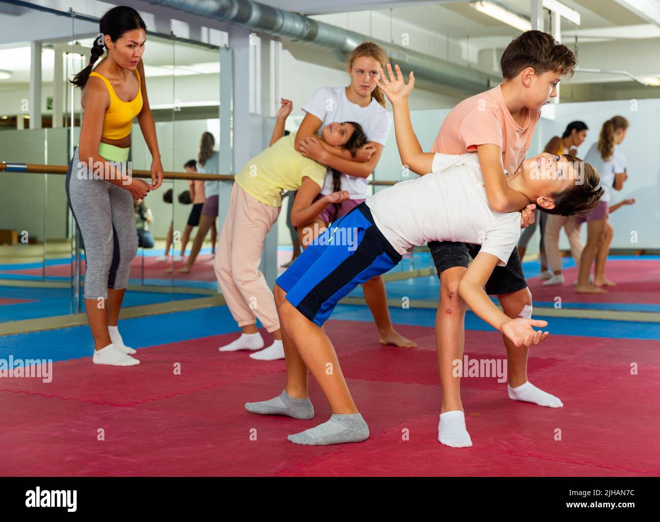 Group of kids training self-defence moves in gym Stock Photo - Alamy