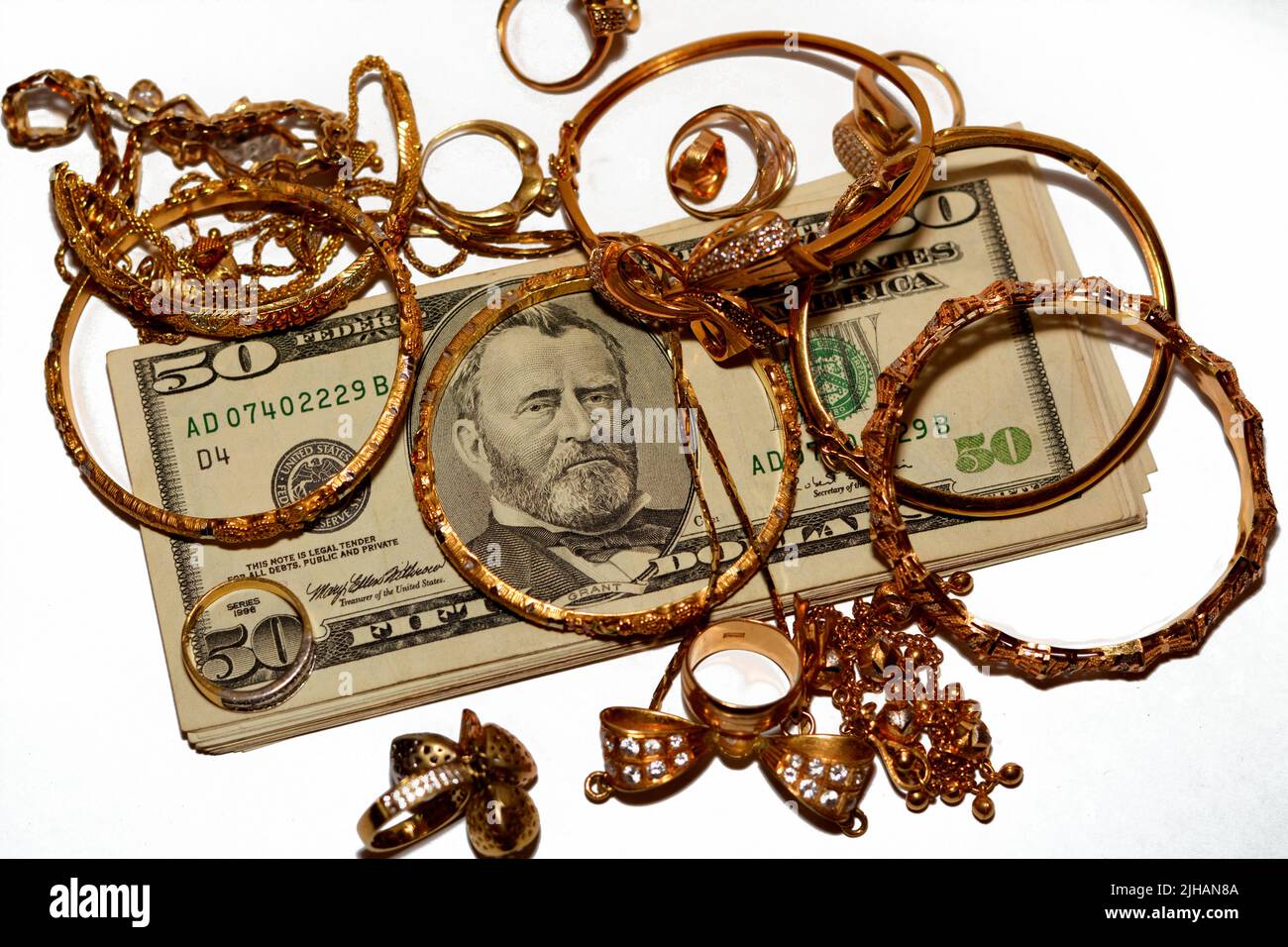 A stack of American dollars money banknotes with a set of gold ...