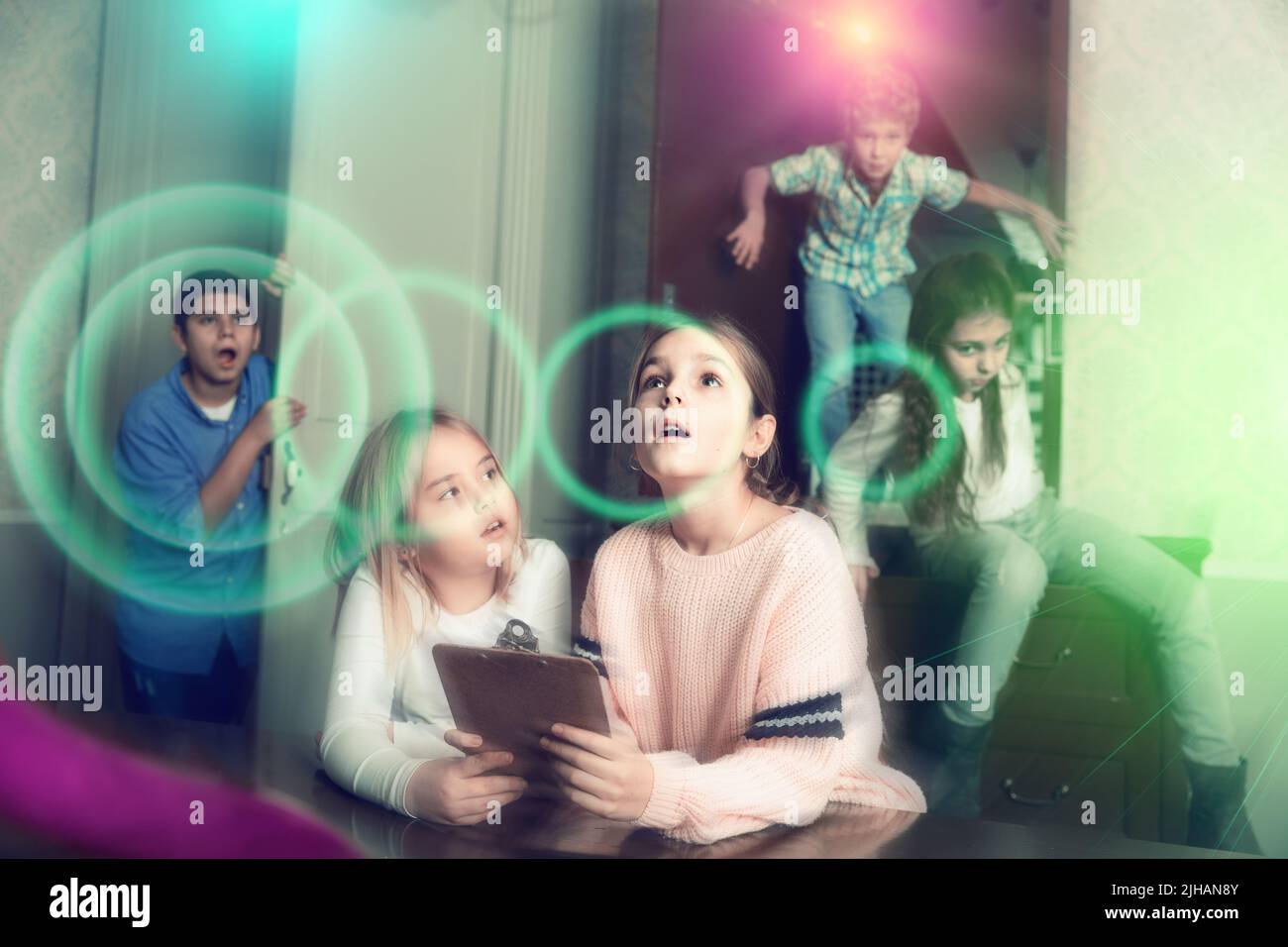 Two preteen girls solving riddles in quest room, toned image Stock ...