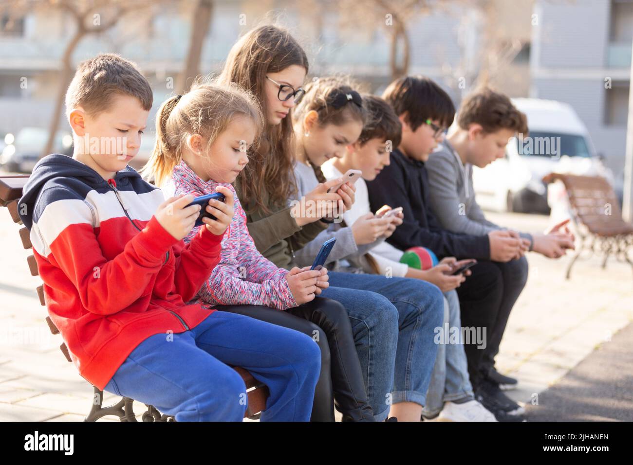 Children addicted in their phones outdoors Stock Photo - Alamy