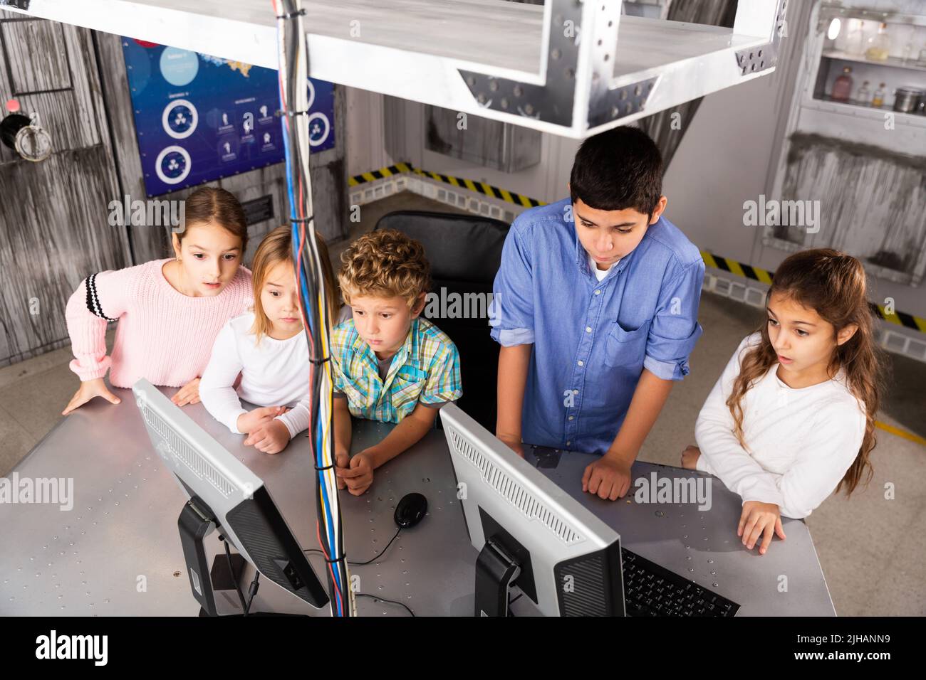 Emotional tween children using computer in quest room shelter Stock ...
