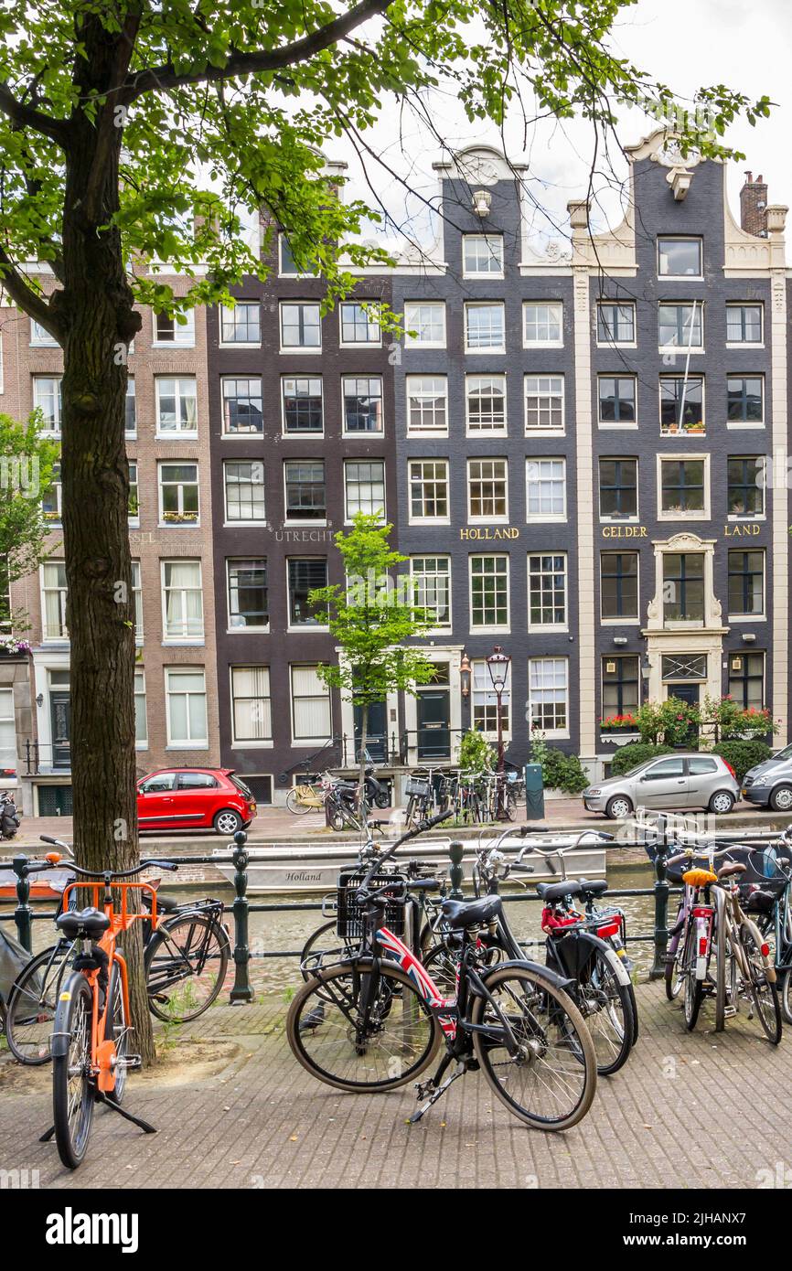 Typical dutch mansion houses with bikes in front along the canals in ...