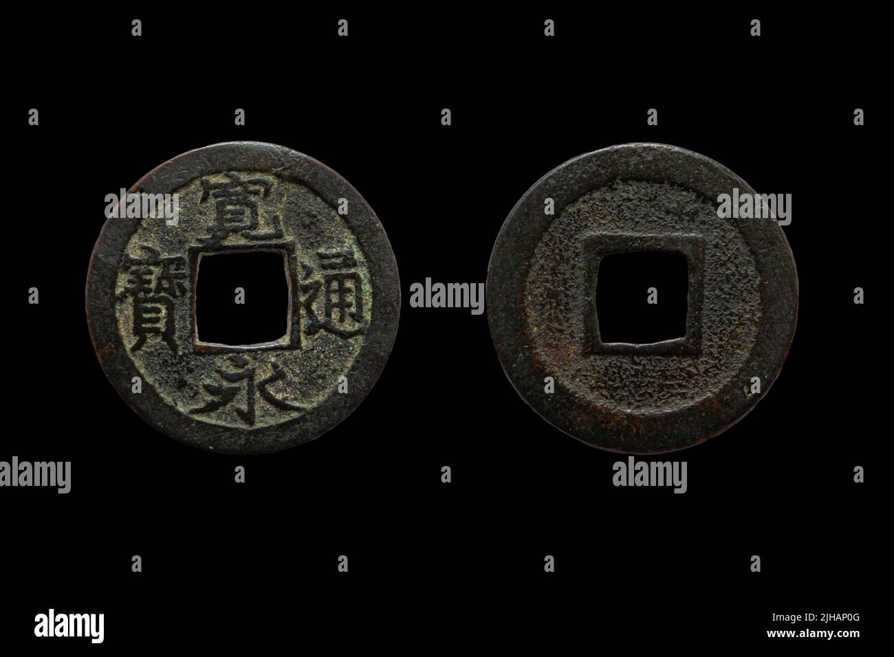 A close-up shot of 17th-century Japanese Mon coins on a black ...