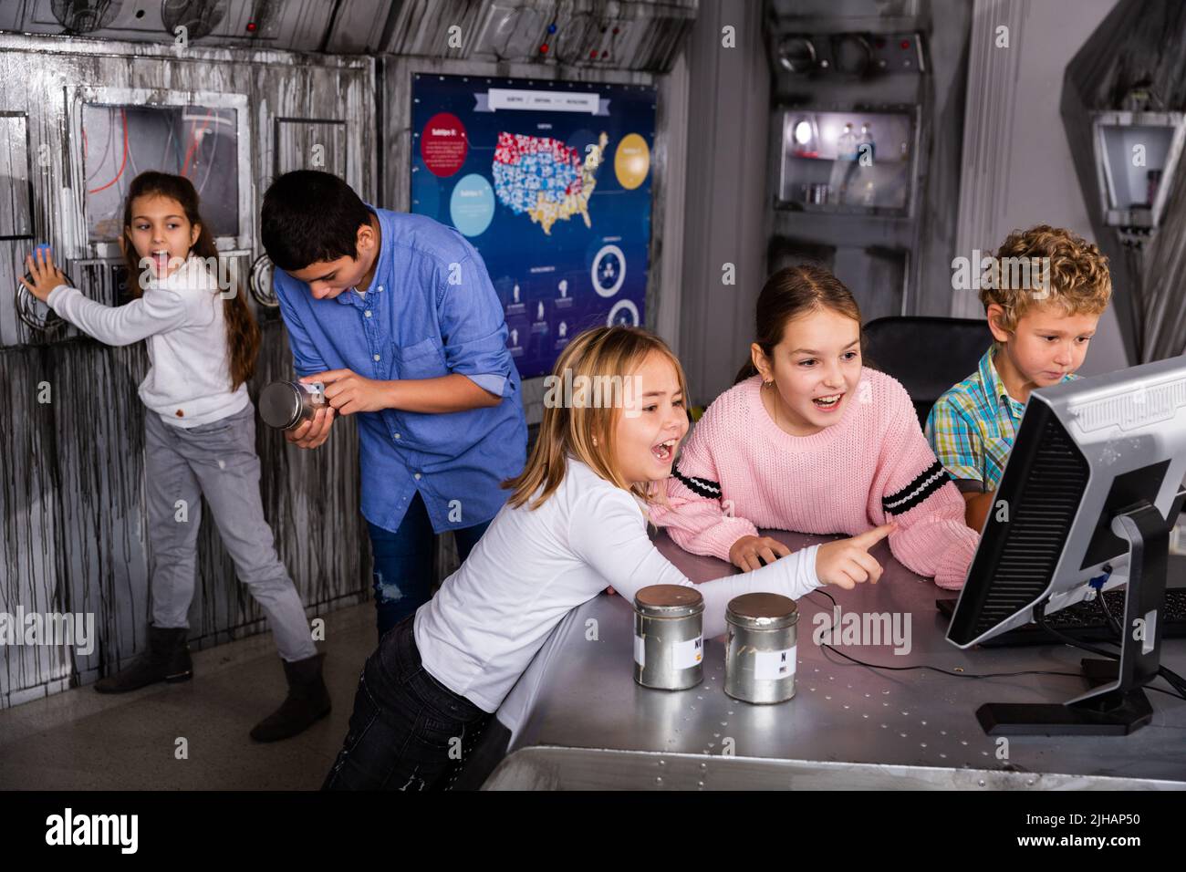 Emotional tween children using computer in quest room shelter Stock ...