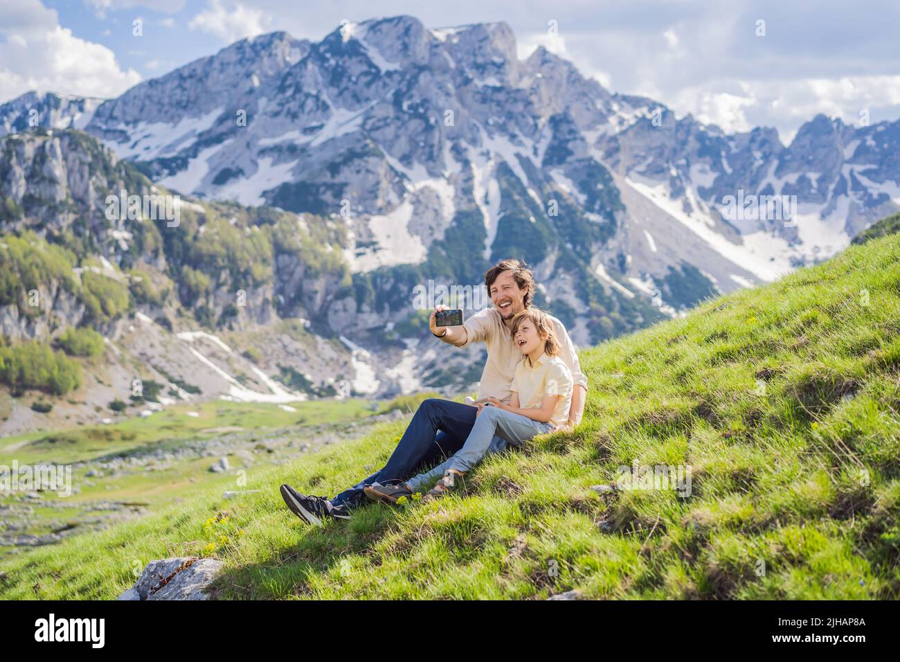 Family of tourists dad and son in Mountain lake landscape on Durmitor ...