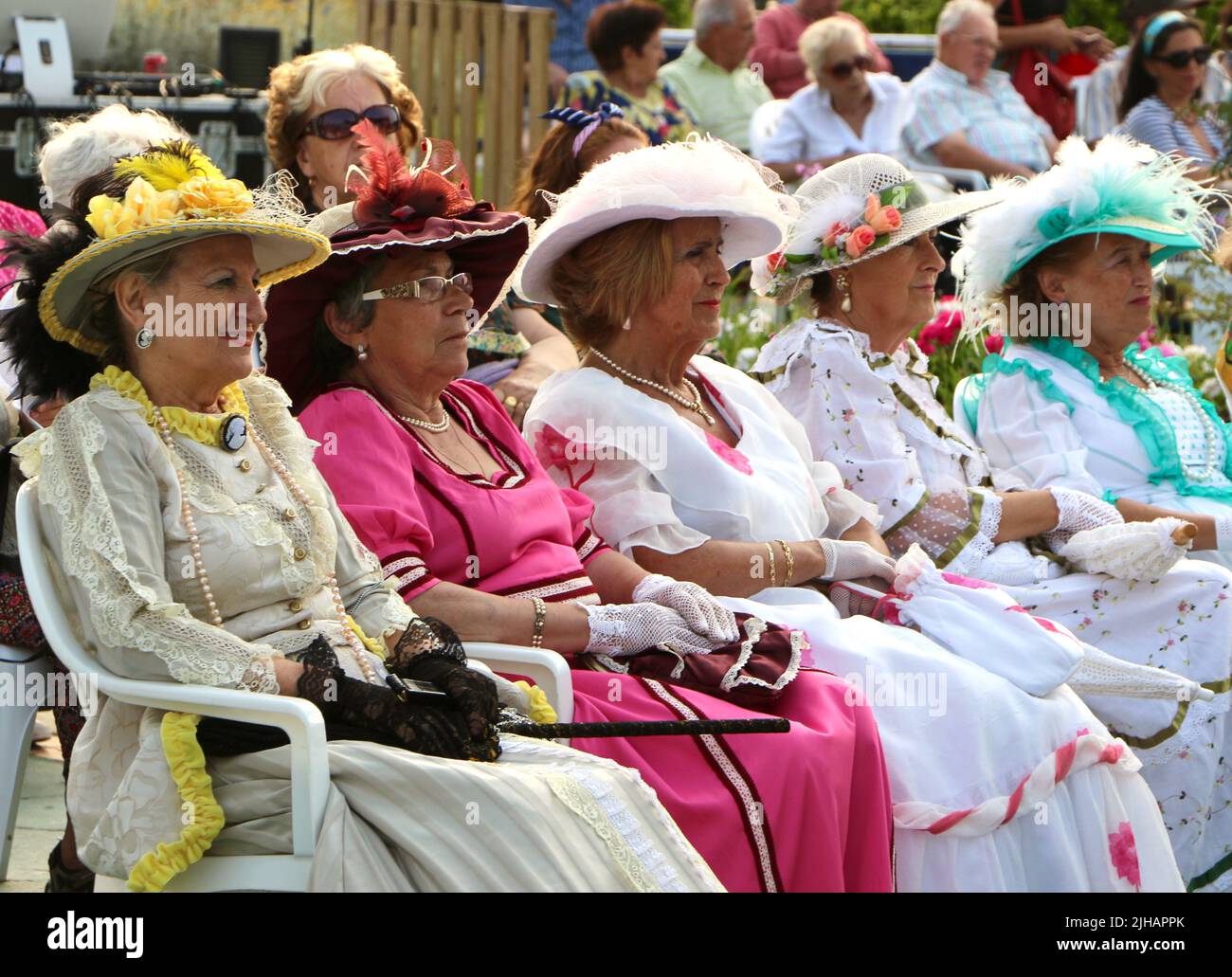 Women dressed in Victorian style dresses to celebrate the Bano de Olas ...