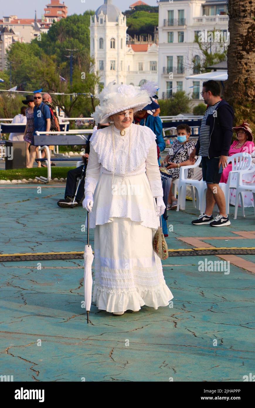 Women dressed in Victorian style dresses to celebrate the Bano de Olas ...