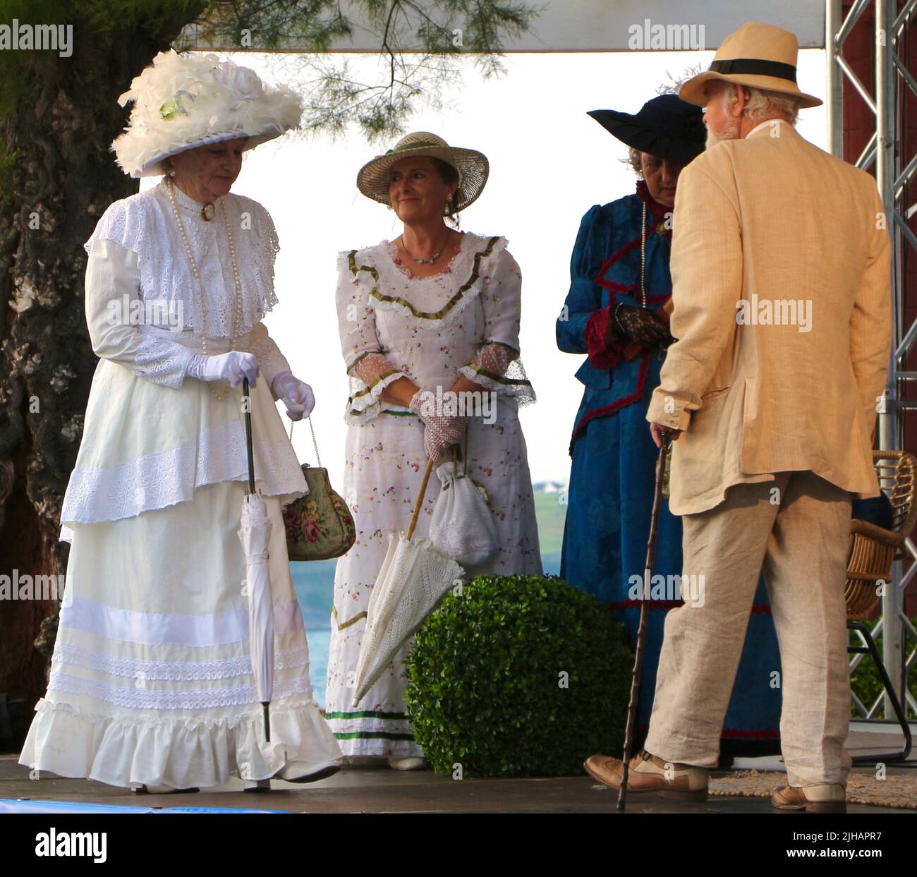 Group of women and a man dressed in Victorian style clothes to ...