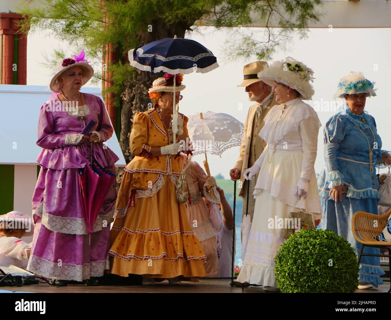 Group of women and a man dressed in Victorian style clothes to ...