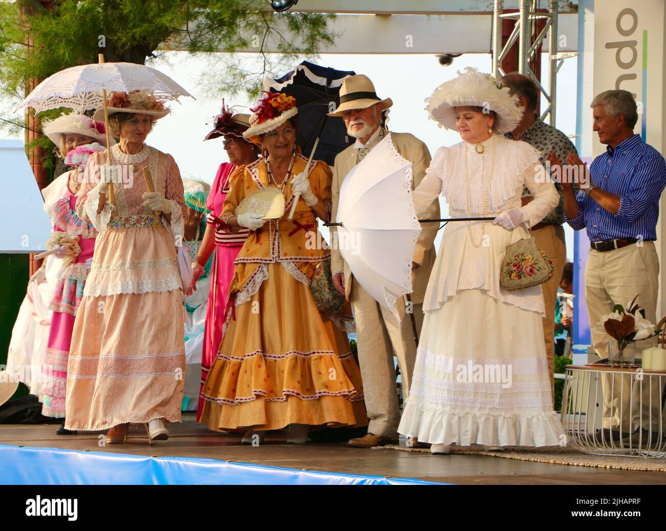 Group of women and a man dressed in Victorian style clothes to ...