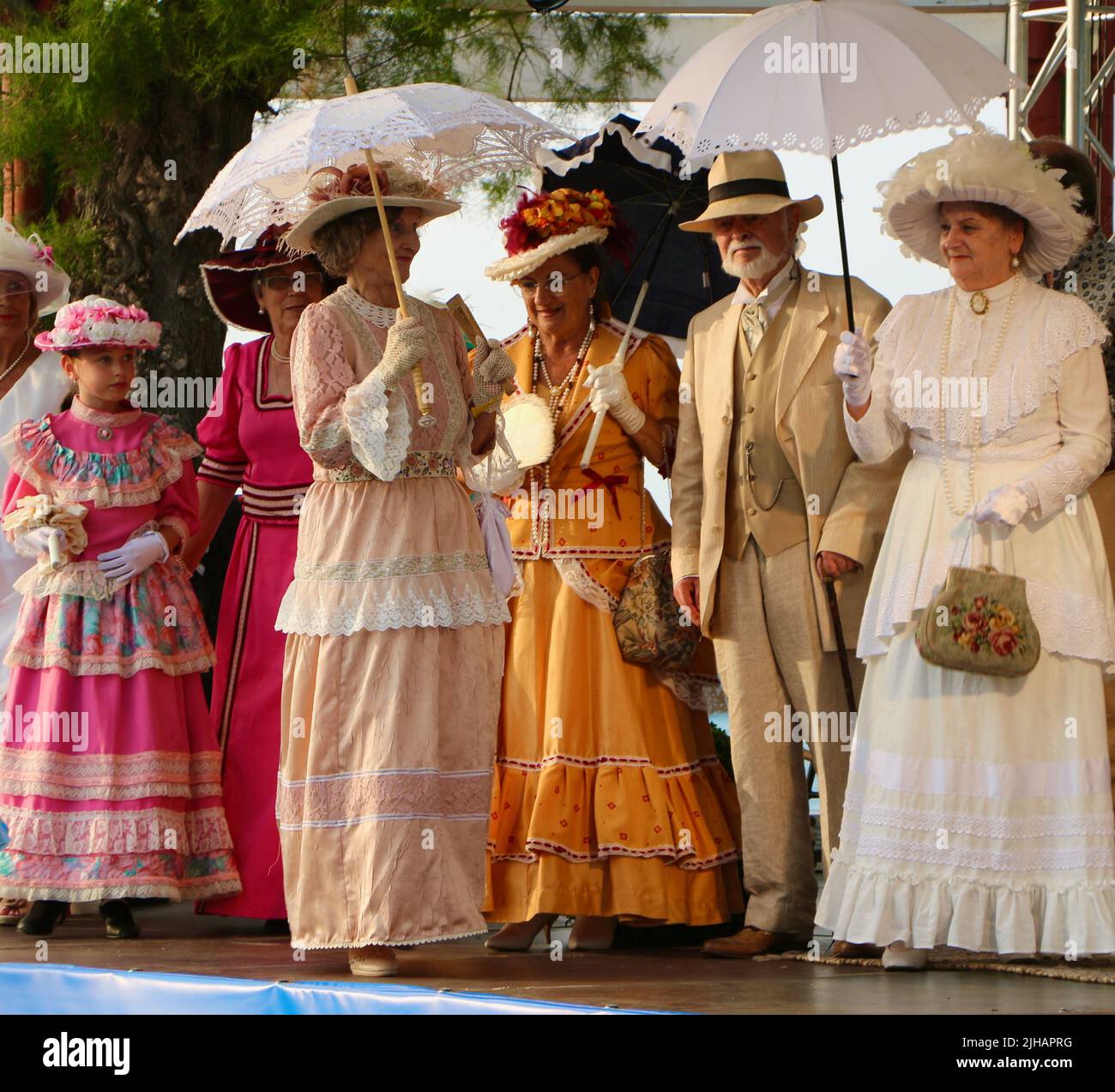Group of women and a man dressed in Victorian style clothes to ...