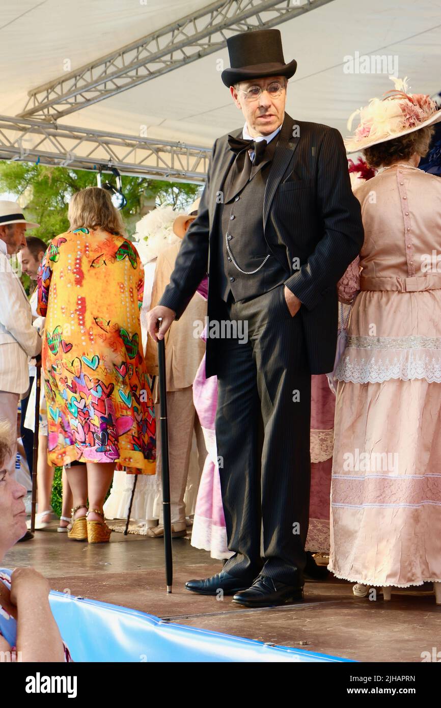 Man wearing Victorian clothes on stage during the Bano de Olas parties ...