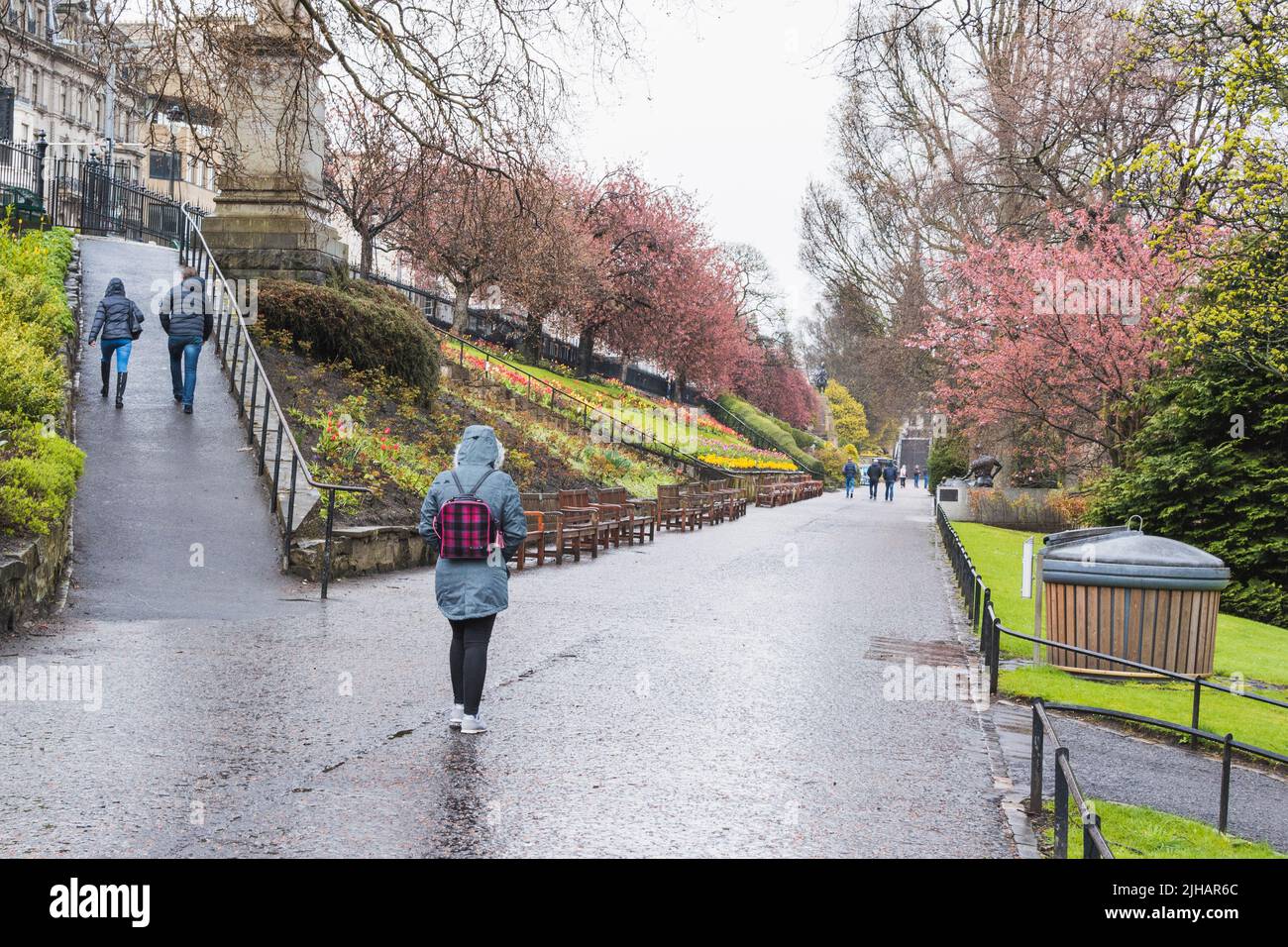 The view of people walking through the park on a rainy day Stock Photo ...