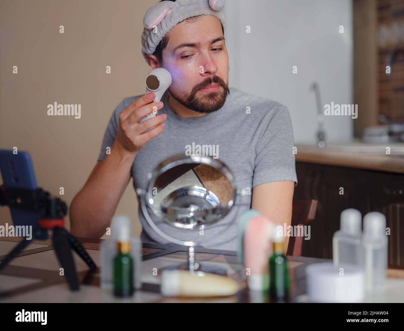 Young man use Ultrasonic Skin Scrubber Exfoliating Wand. Skin care and ...