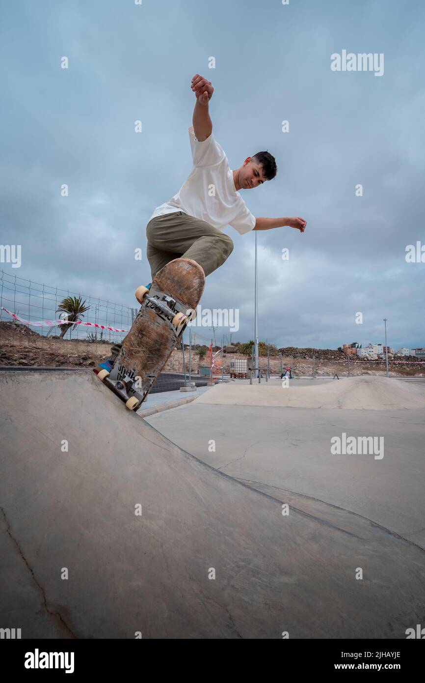 young skateboarder jumps over a ramp in a skate park Stock Photo - Alamy