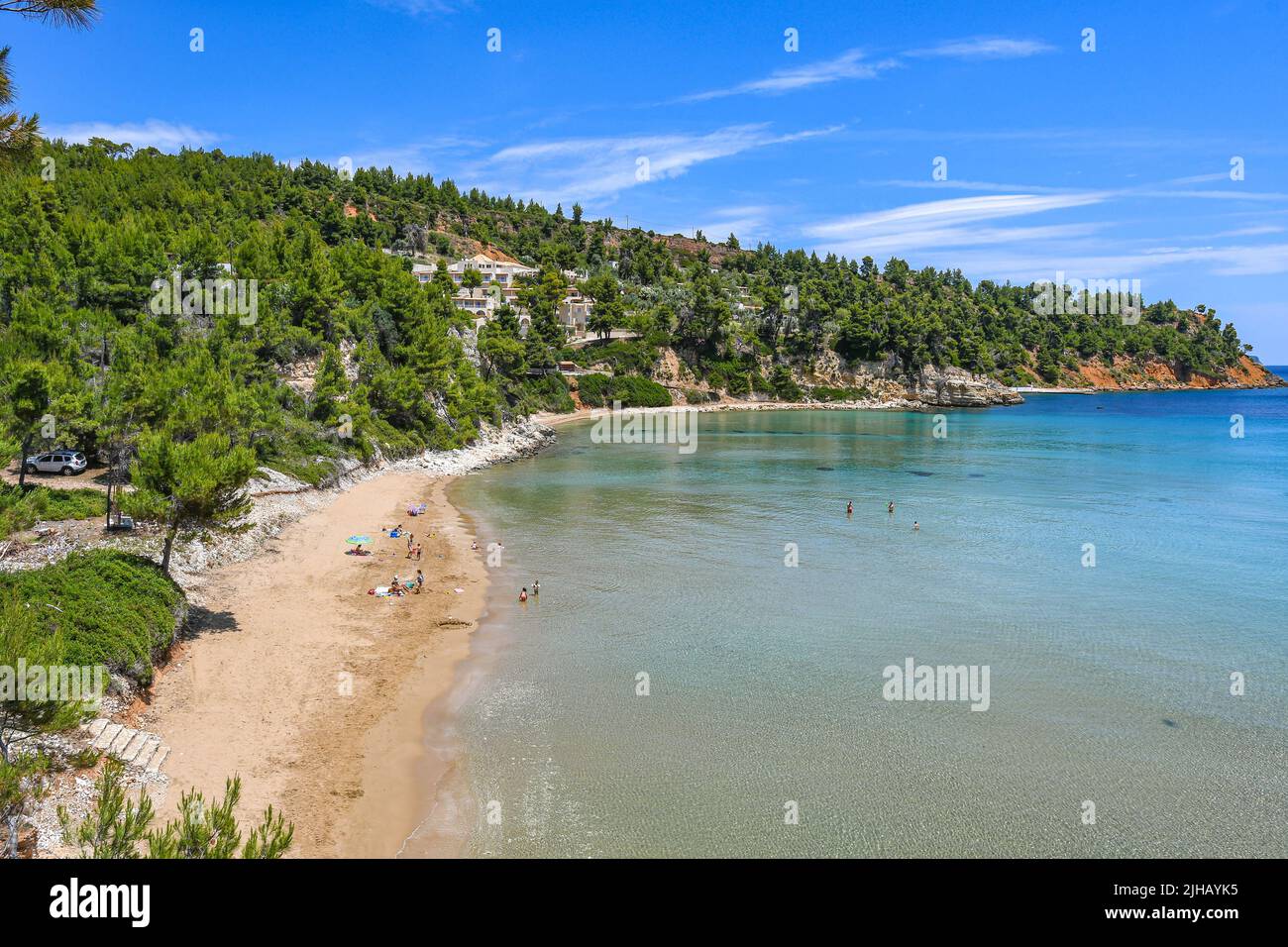 Beautiful Summer scenery with a lot of swimmers at Chrisi Milia beach ...