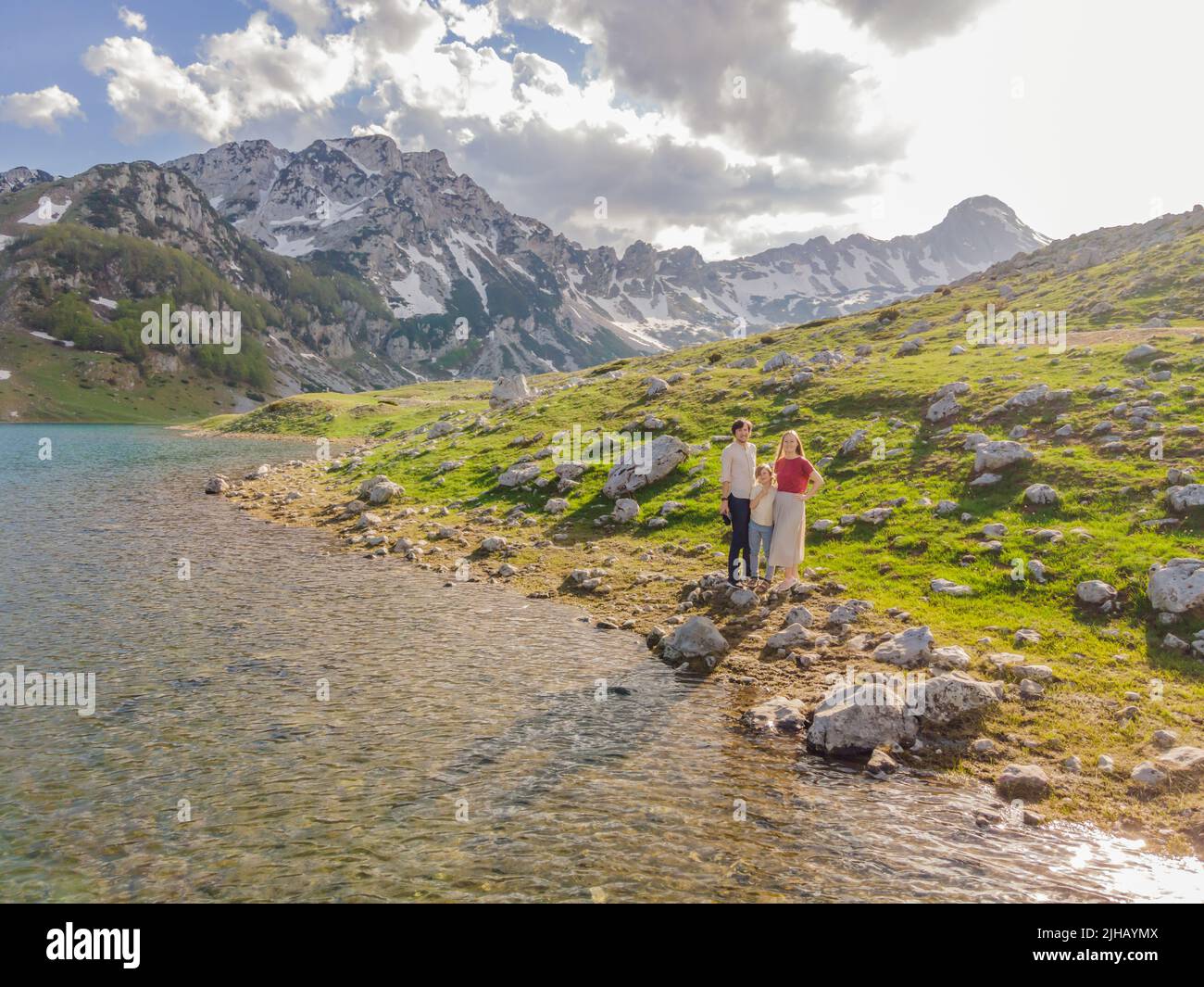Family of tourists mom, dad and son in Mountain lake landscape on ...