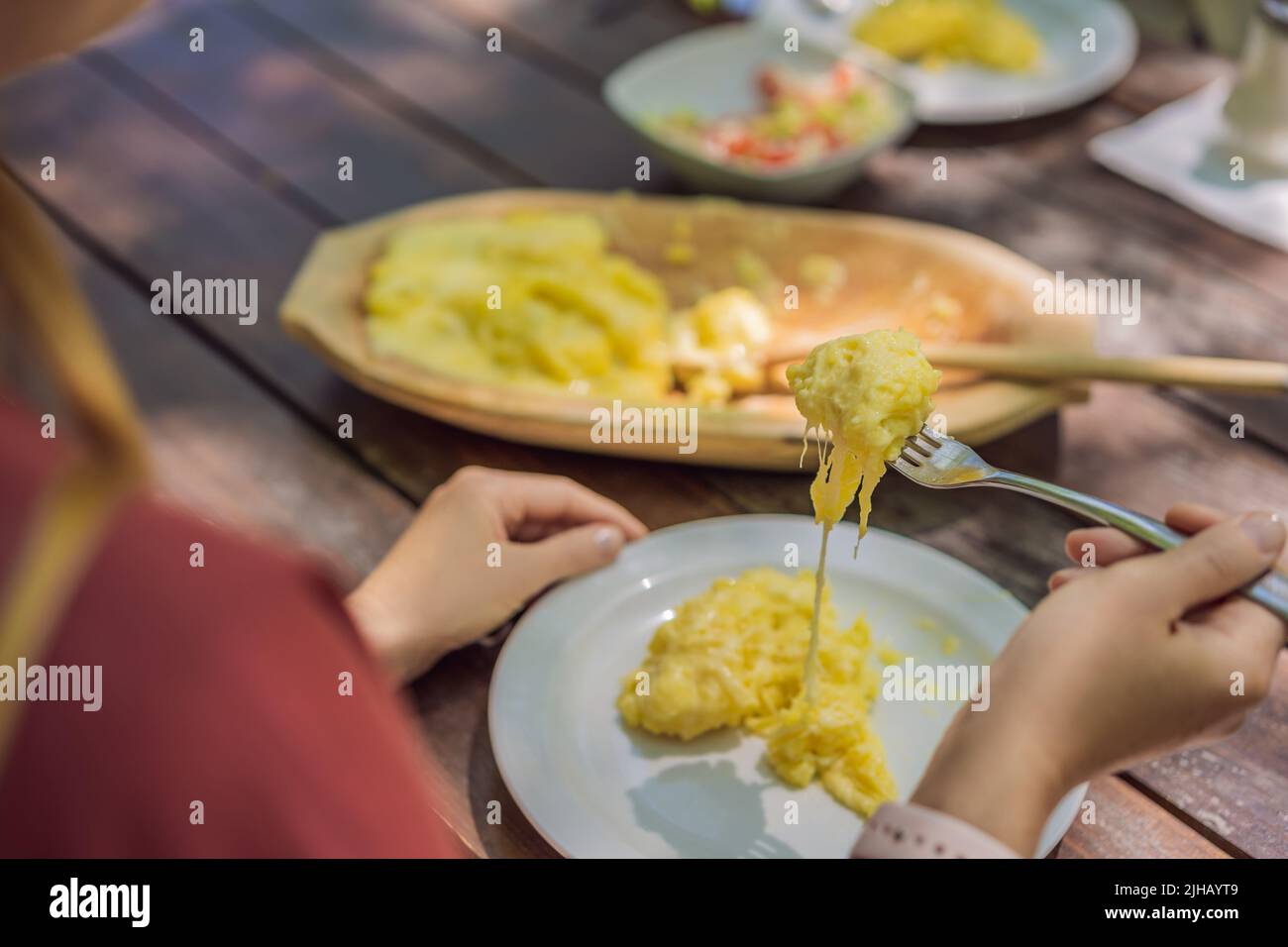 Traditional Montenegrin Meal. Kacamak in wooden bowl in the outdoor ...