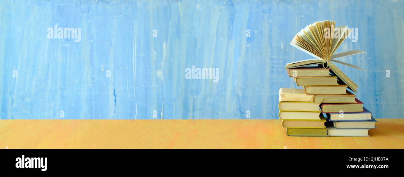 open book on a stack of books, reading, education,learning, home office ...