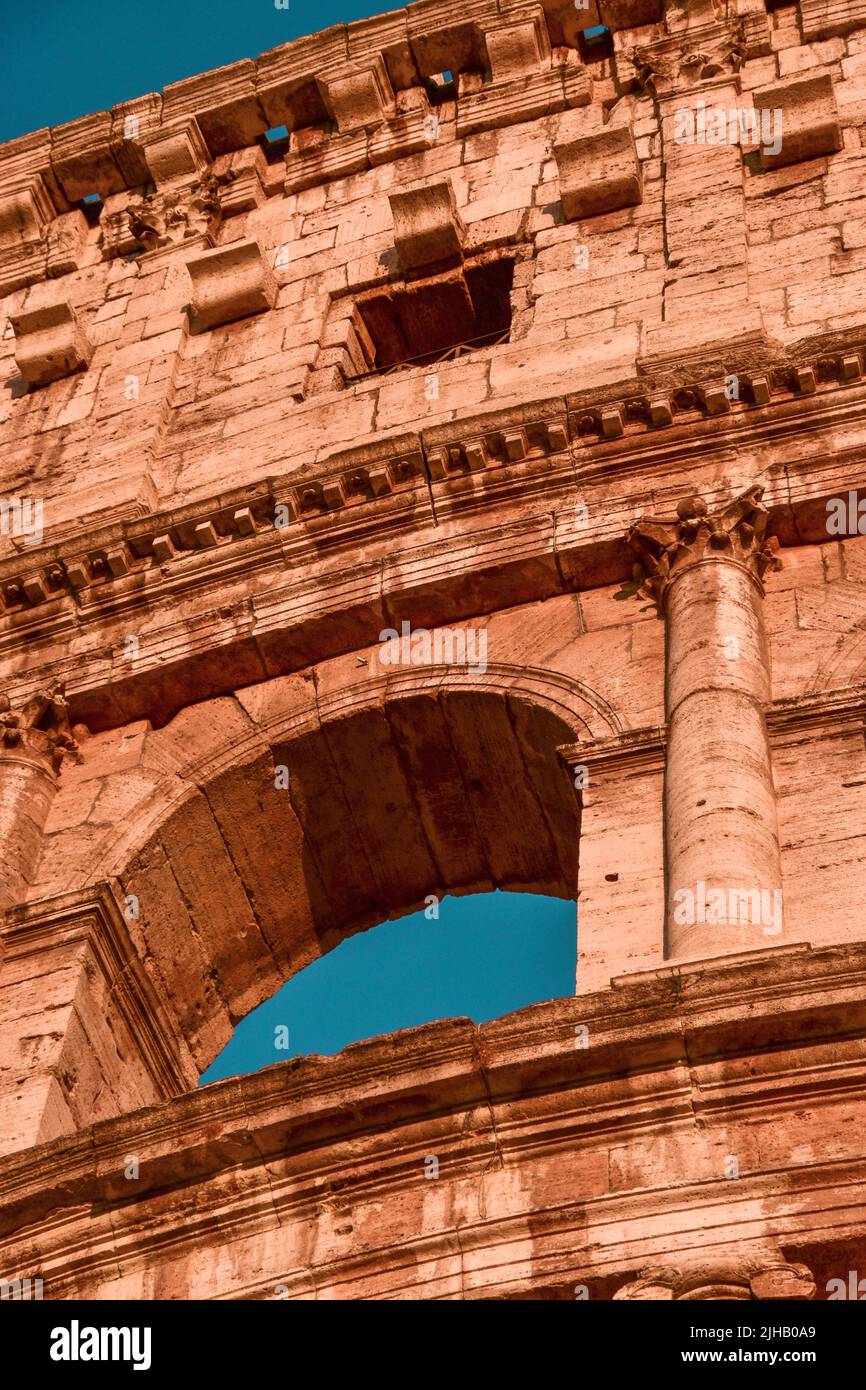 The close-up partial view of historic Colosseum against the blue sky ...