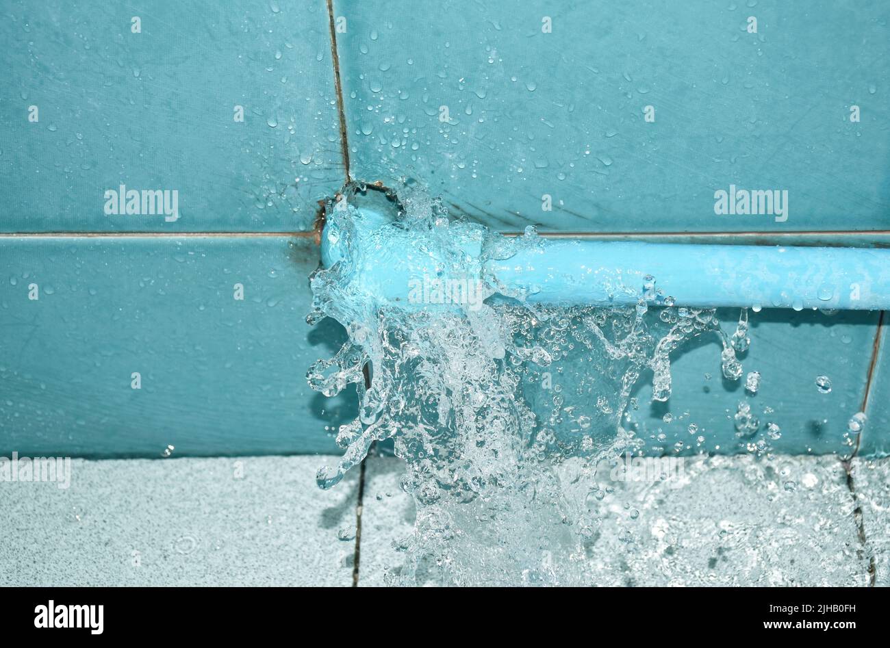water splashing from broken plumbing blue polythene pipe line in ...