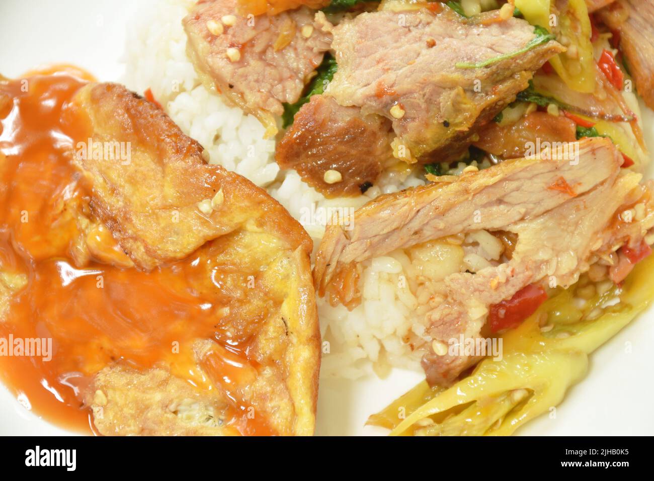spicy stir fried barbecue pork neck with chili and basil leaf topping ...