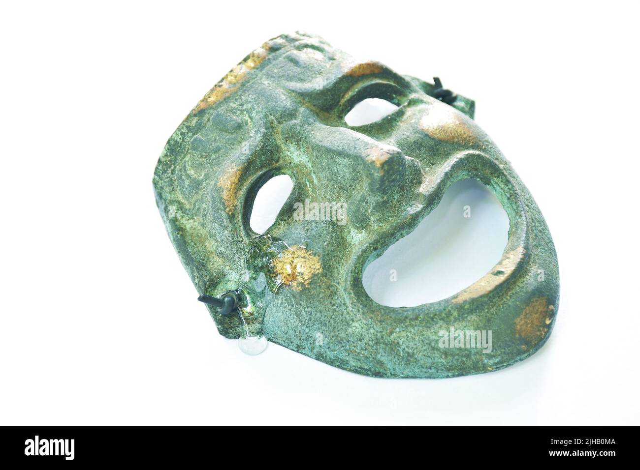 iron human face mask smiling with tear drop on white background Stock ...