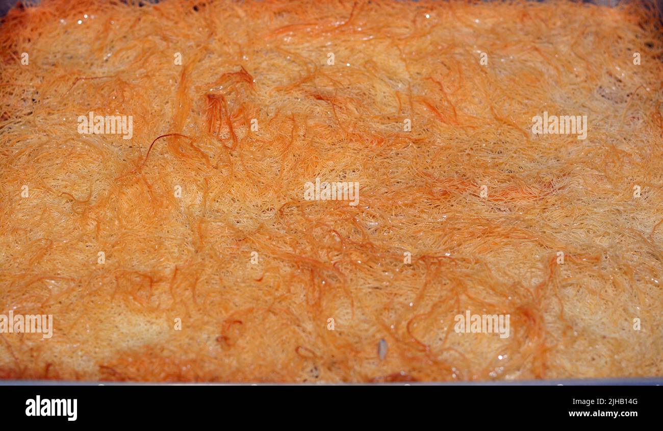 A traditional middle eastern dessert Knafeh made with spun pastry ...