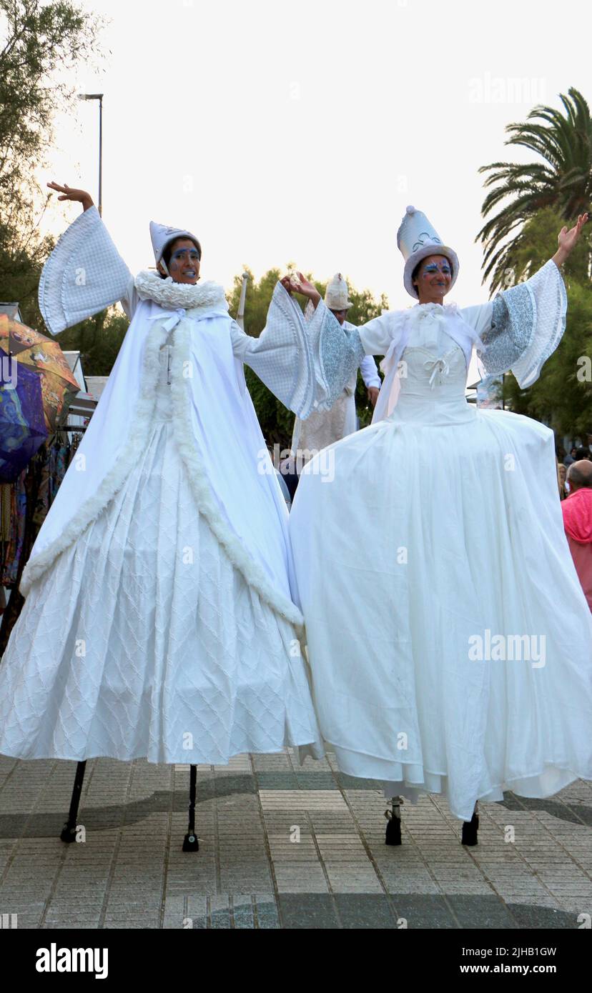 Two Bambolea circus performers public event on stilts and in white ...