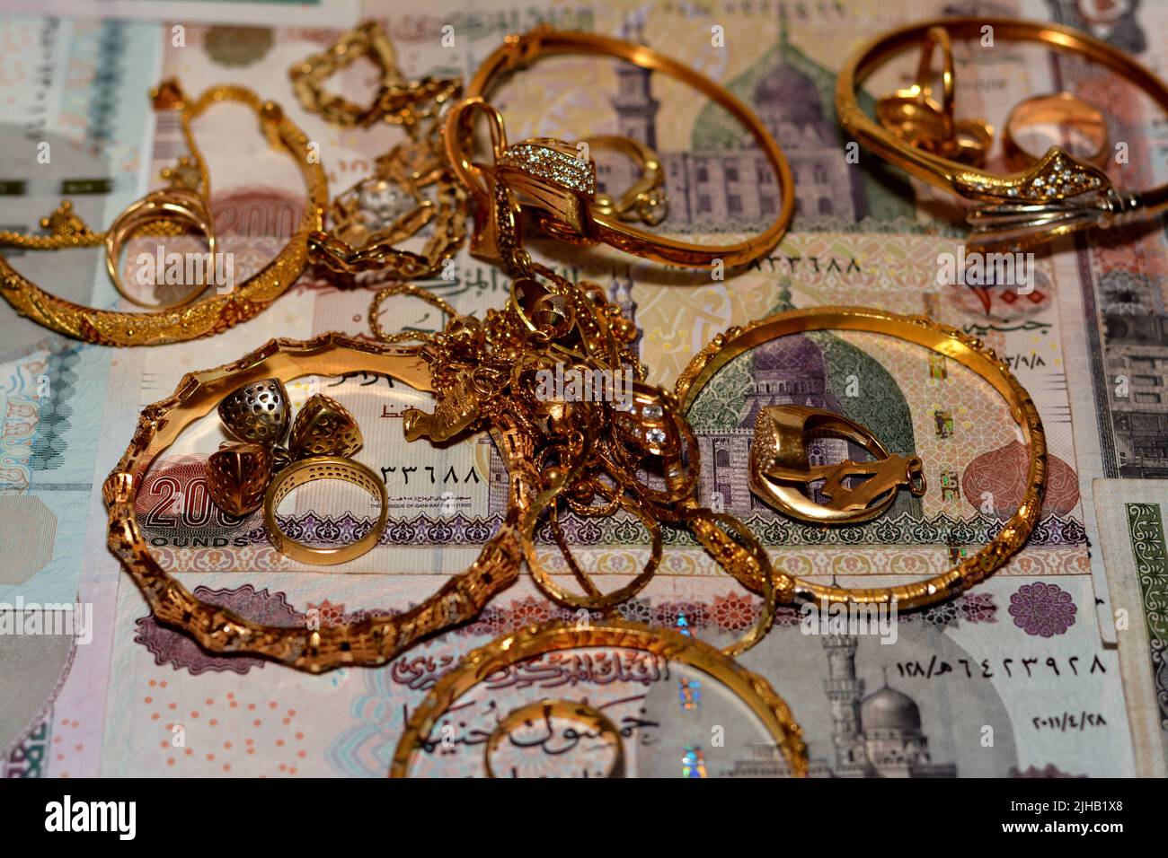 Egyptian pounds banknotes money of different values with a set of gold ...