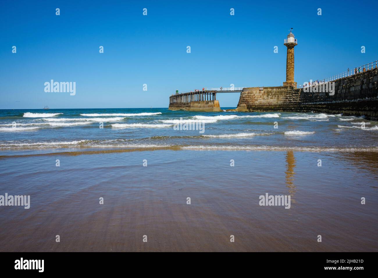 View of the west pier at Whitby showing the lighthouse and the bridge ...