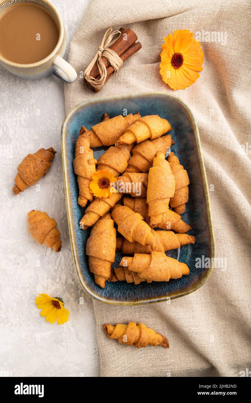 Homemade bagel roll with cup of coffee on a gray concrete background ...